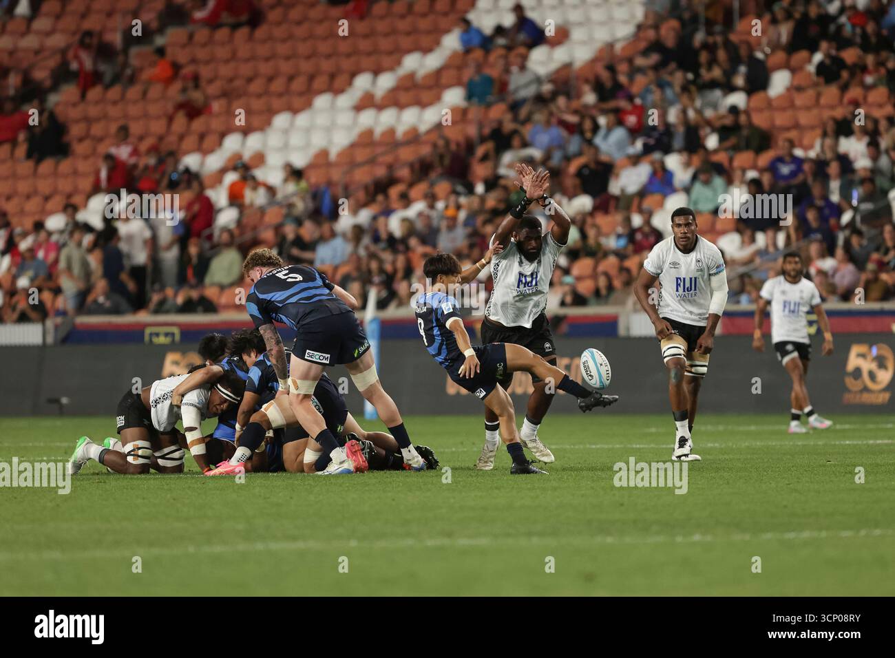 Japan's Shinobu Fujiwara kicks the ball against Fiji's Temo Mayanavanua ...