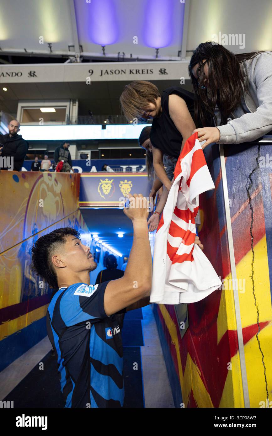 Japan's Kenta Fukuda signs an autograph after the game against Fiji at ...