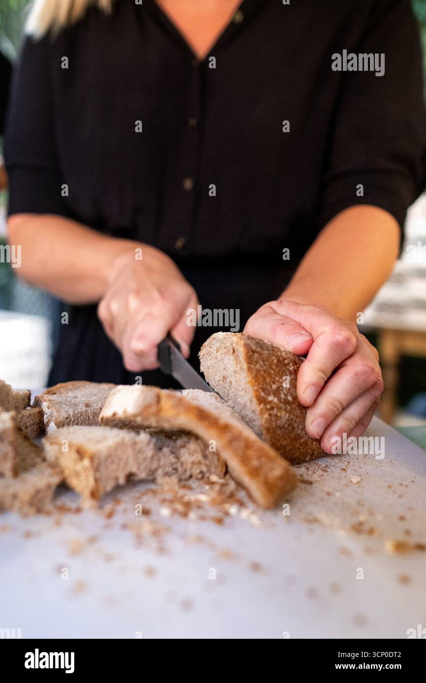Freshly baked sourdough bread in a wicker basket at a reception event ...