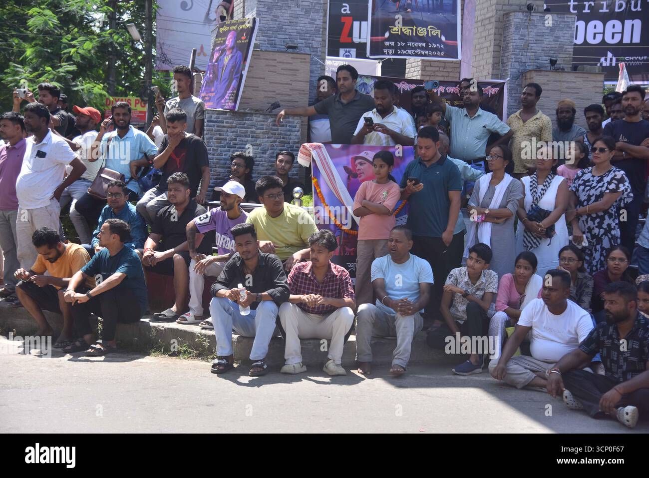 People watch a live broadcast of Zubeen Garg's funeral in Nagaon ...