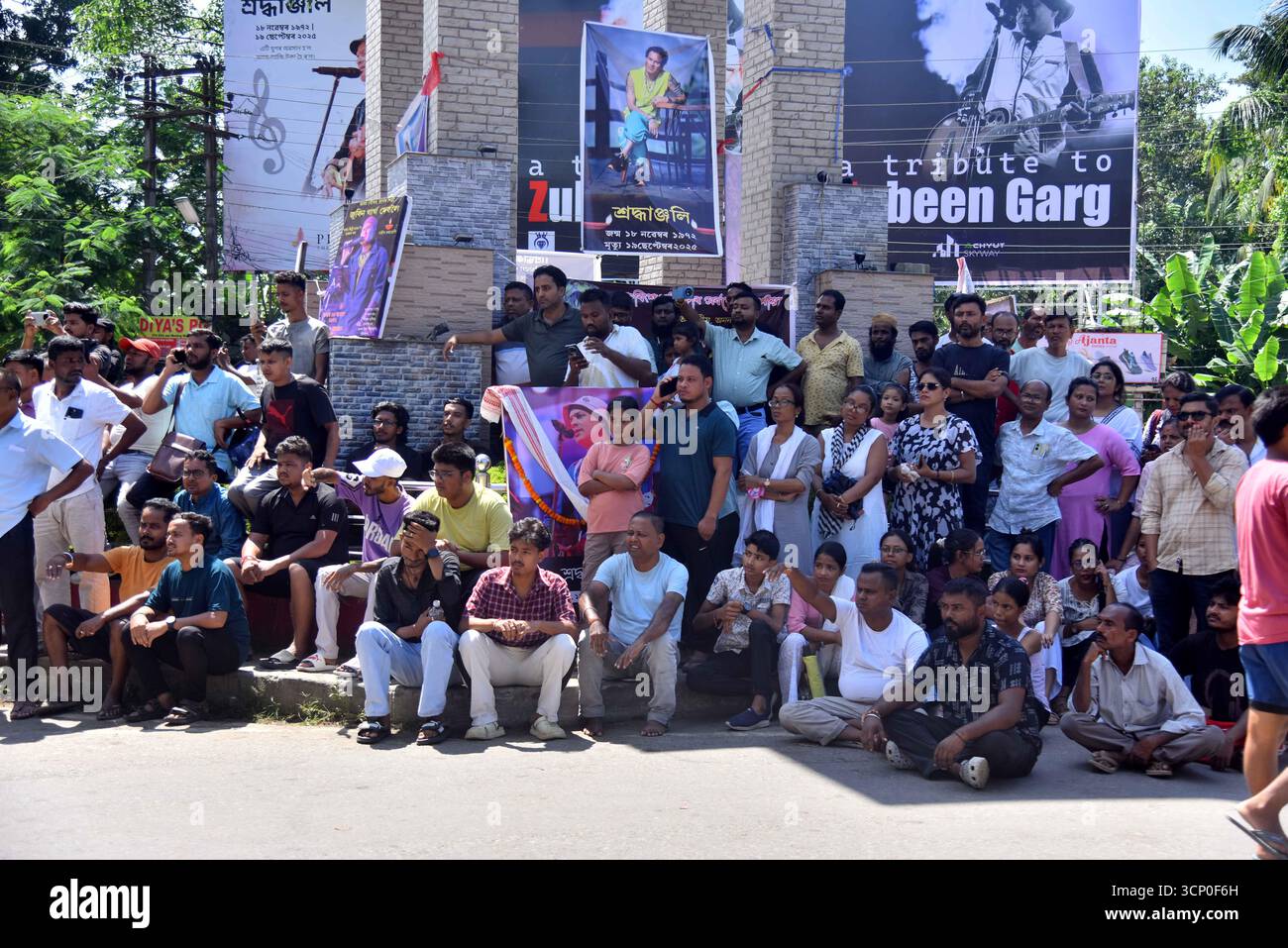 People watch a live broadcast of Zubeen Garg's funeral in Nagaon ...