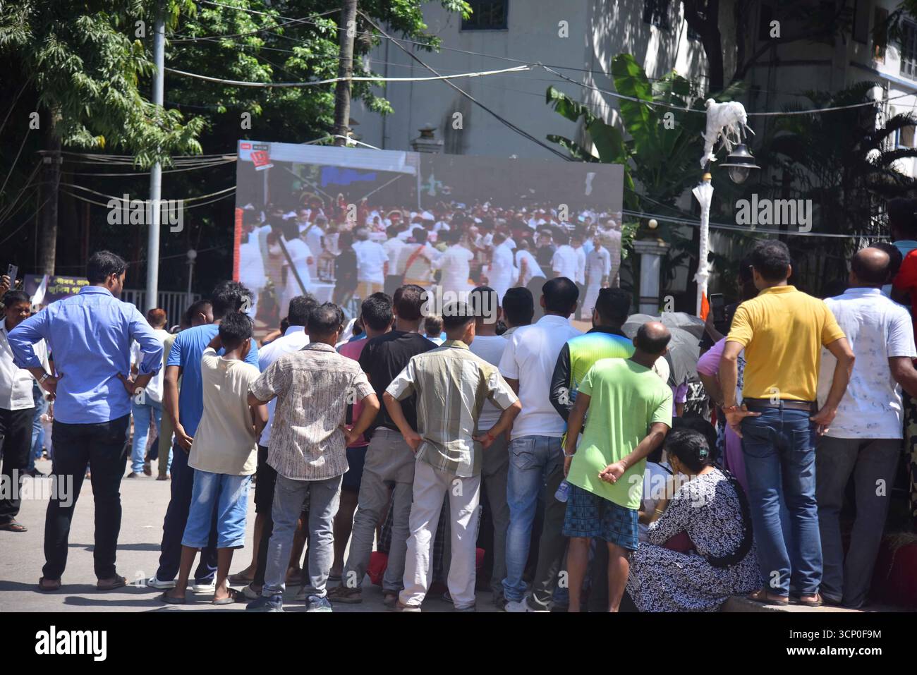 People watch a live broadcast of Zubeen Garg's funeral in Nagaon ...