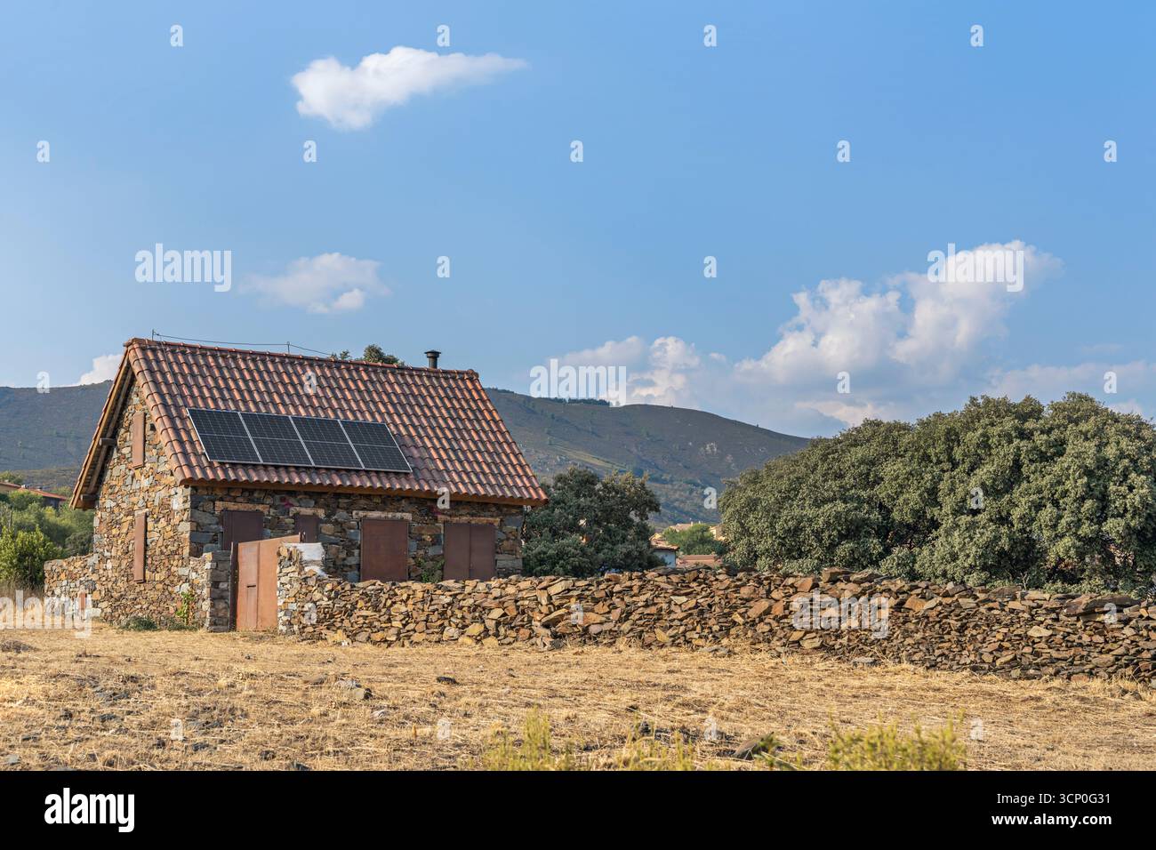 Stone building with small, mountain-style windows, a plot with a ...