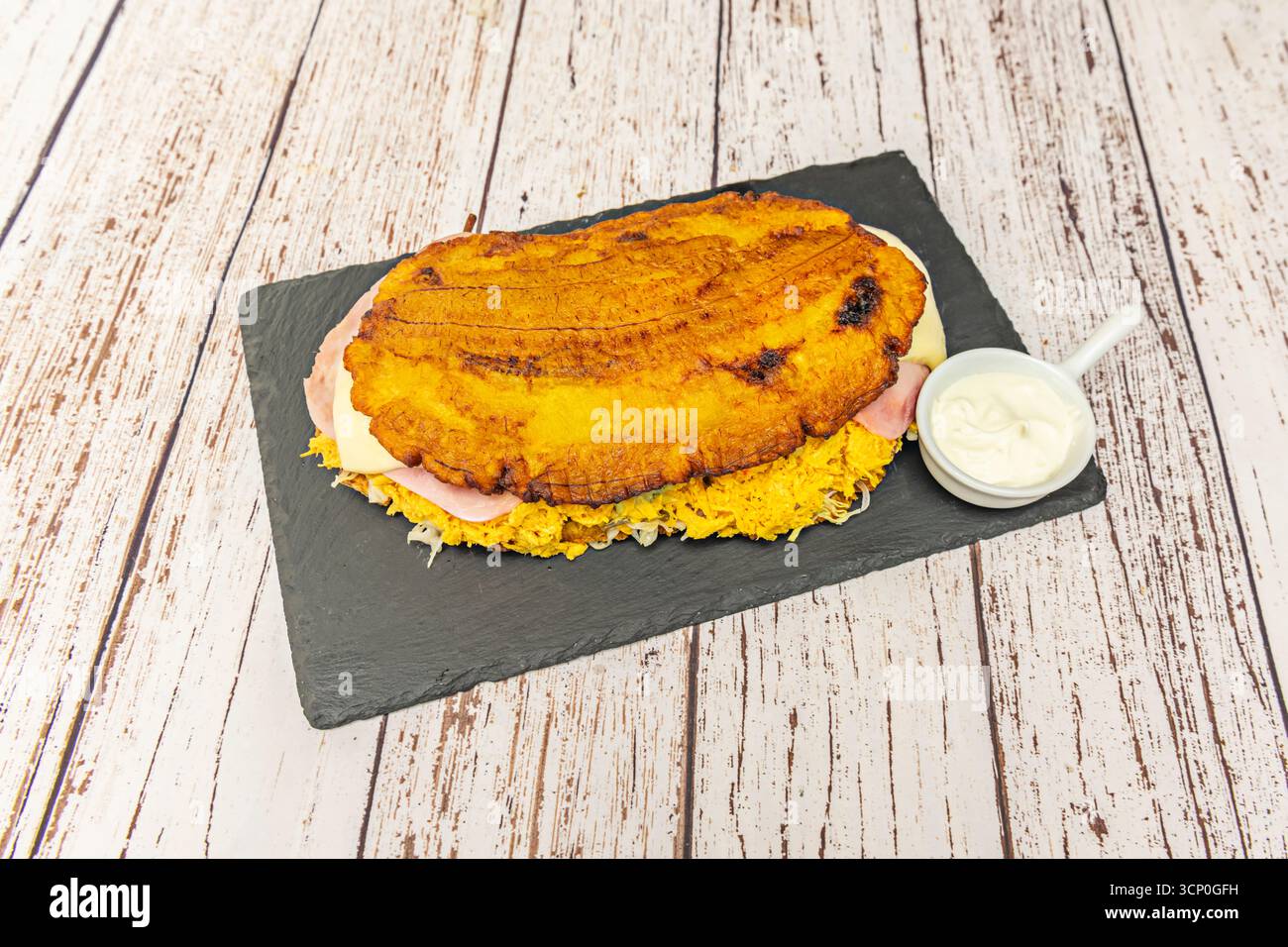Crispy Venezuelan patacones freshly removed from the oil, arranged in a ...
