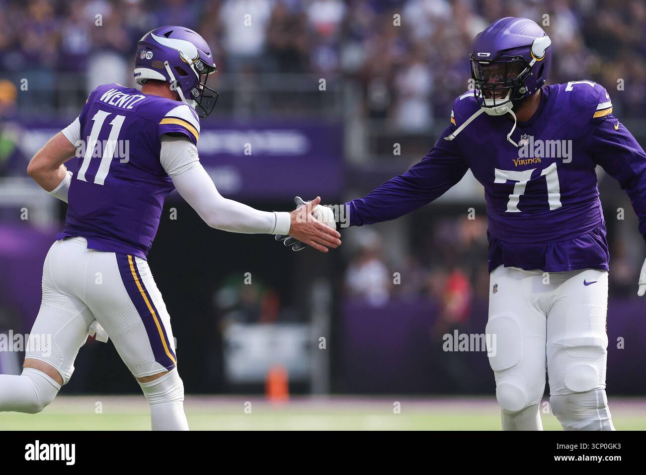 Minnesota Vikings quarterback Carson Wentz (11) high-fives offensive ...