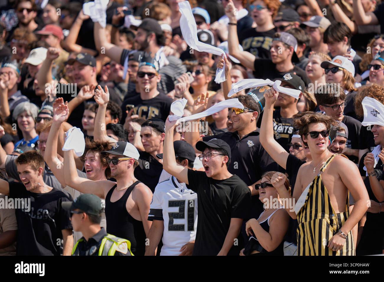 Fans cheer during the first half of an NCAA college football game ...