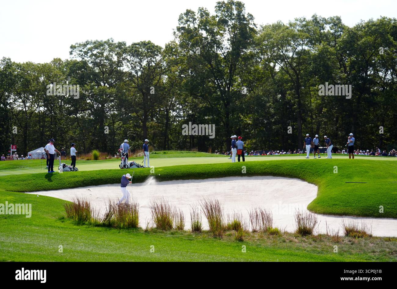 Collin Morikawa of Team United States plays from a bunker during a ...