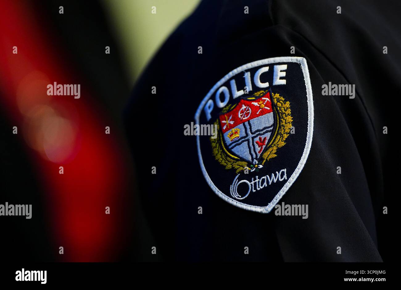 An Ottawa Police Service patch is seen on an officer's uniform during ...