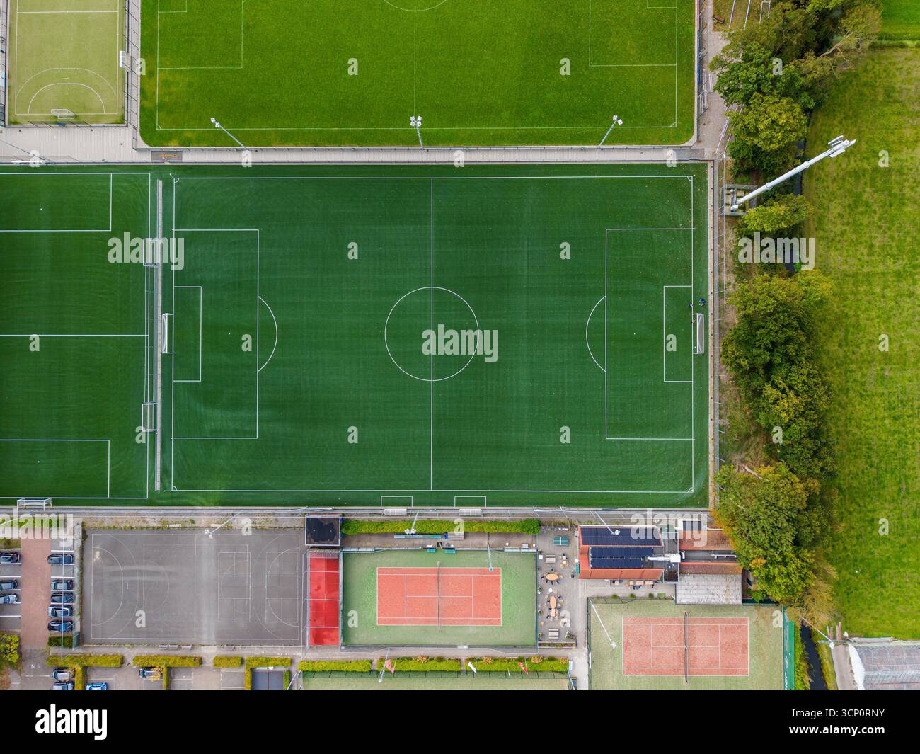 Aerial view of a sports complex with a full size soccer field, smaller ...