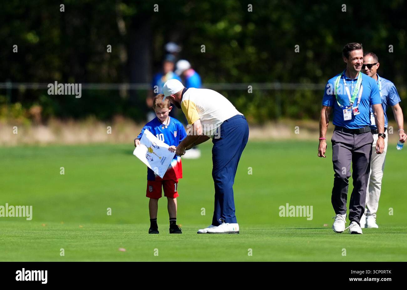 Shane Lowry of Team Europe signs an autograph for a young spectator at ...