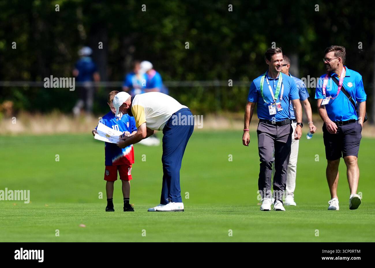 Shane Lowry of Team Europe signs an autograph for a young spectator at ...