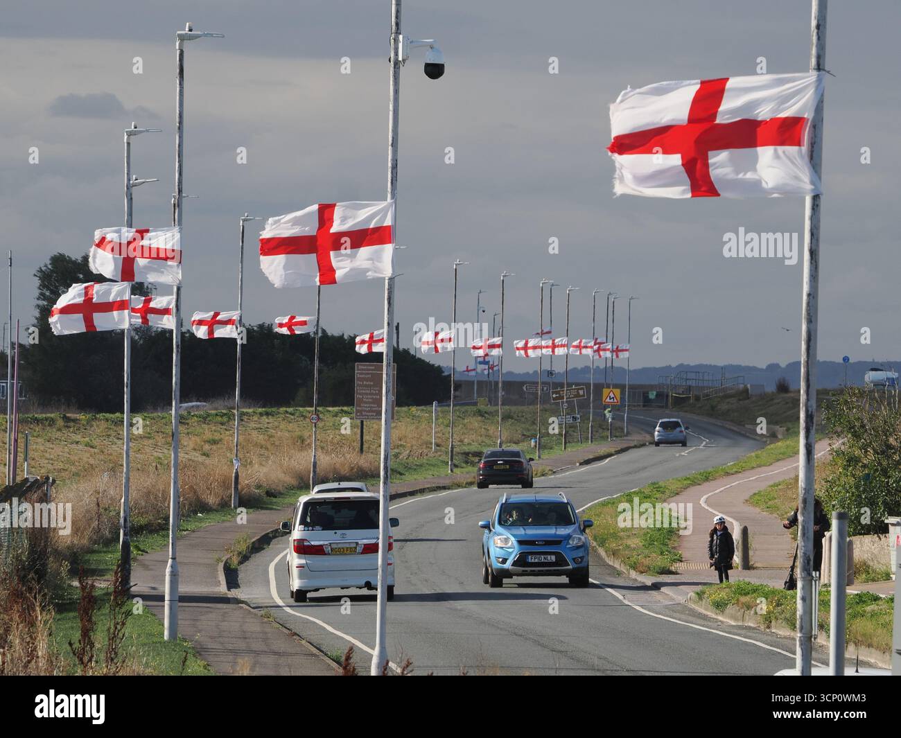 Sheerness, Kent, UK. 23rd Sep, 2025. The long line of St George flags ...