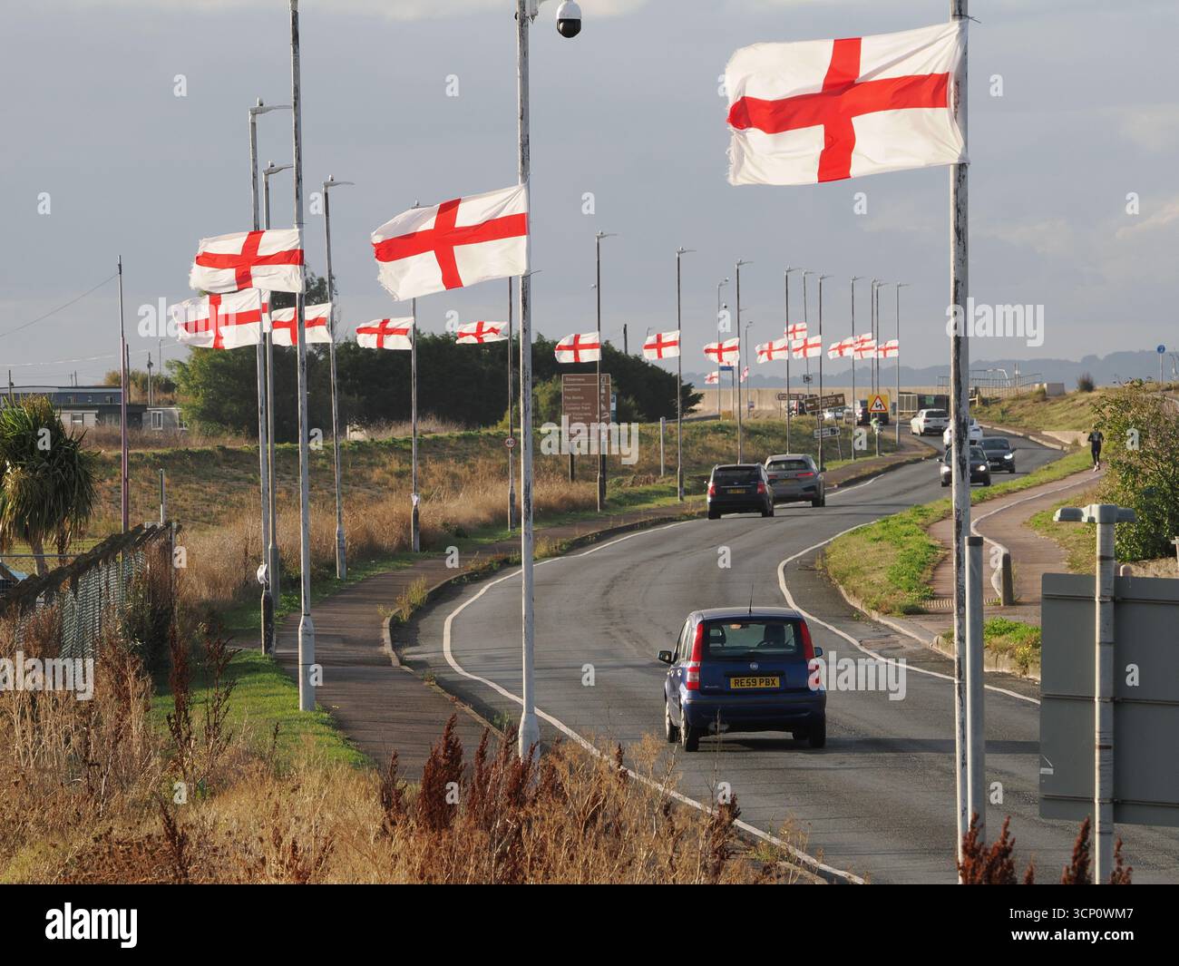 Sheerness, Kent, UK. 23rd Sep, 2025. The long line of St George flags ...