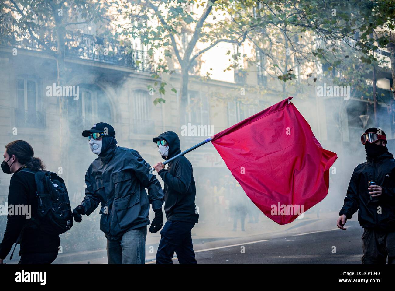 Protesters walk towards police front waving a red flag during the rally ...