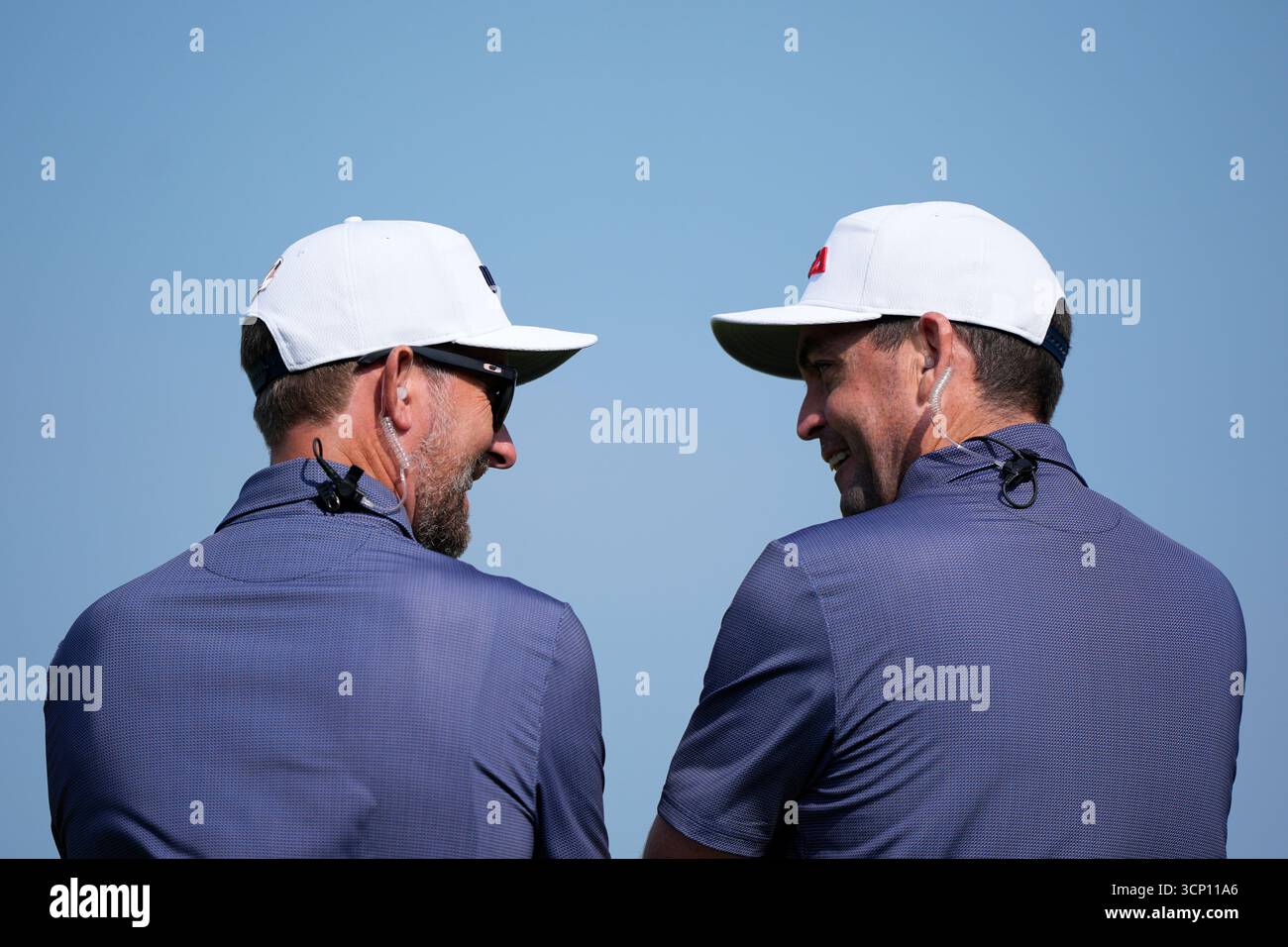 United States Captain Keegan Bradley and Webb Simpson watch during a ...