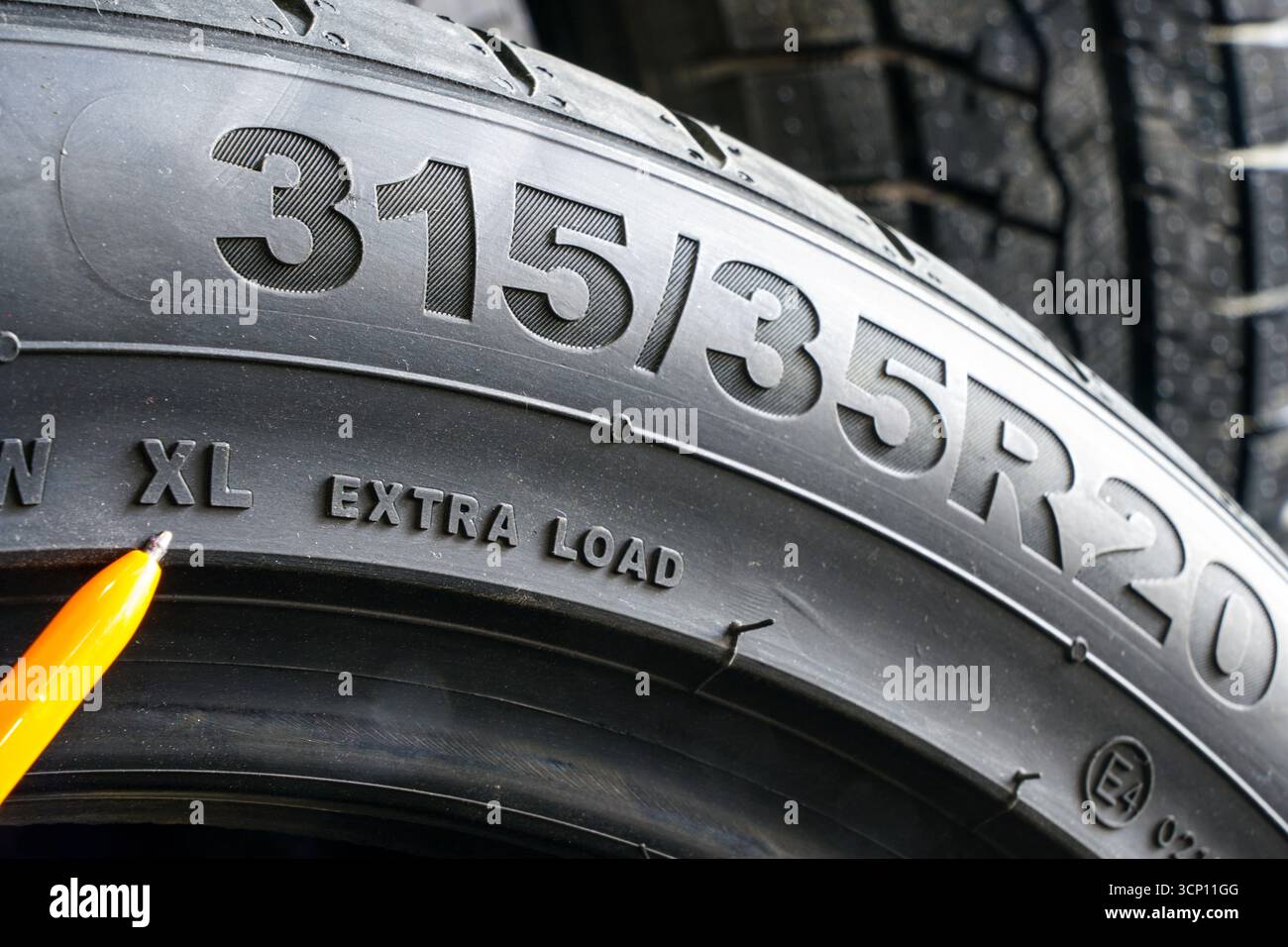 A detailed close-up of the sidewall of a car tire showing the tire size ...