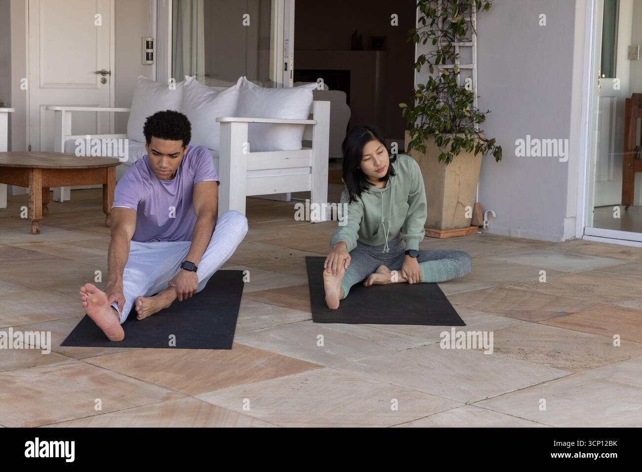 Woman performing seated hamstring hi-res stock photography and images ...