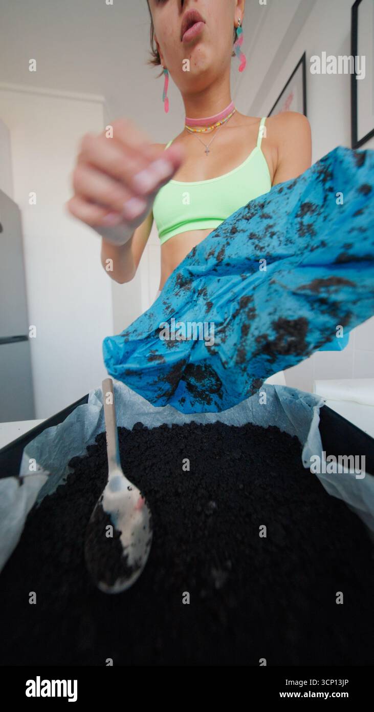 A Woman Skillfully Handling Soil in a Modern Kitchen Setting with a ...