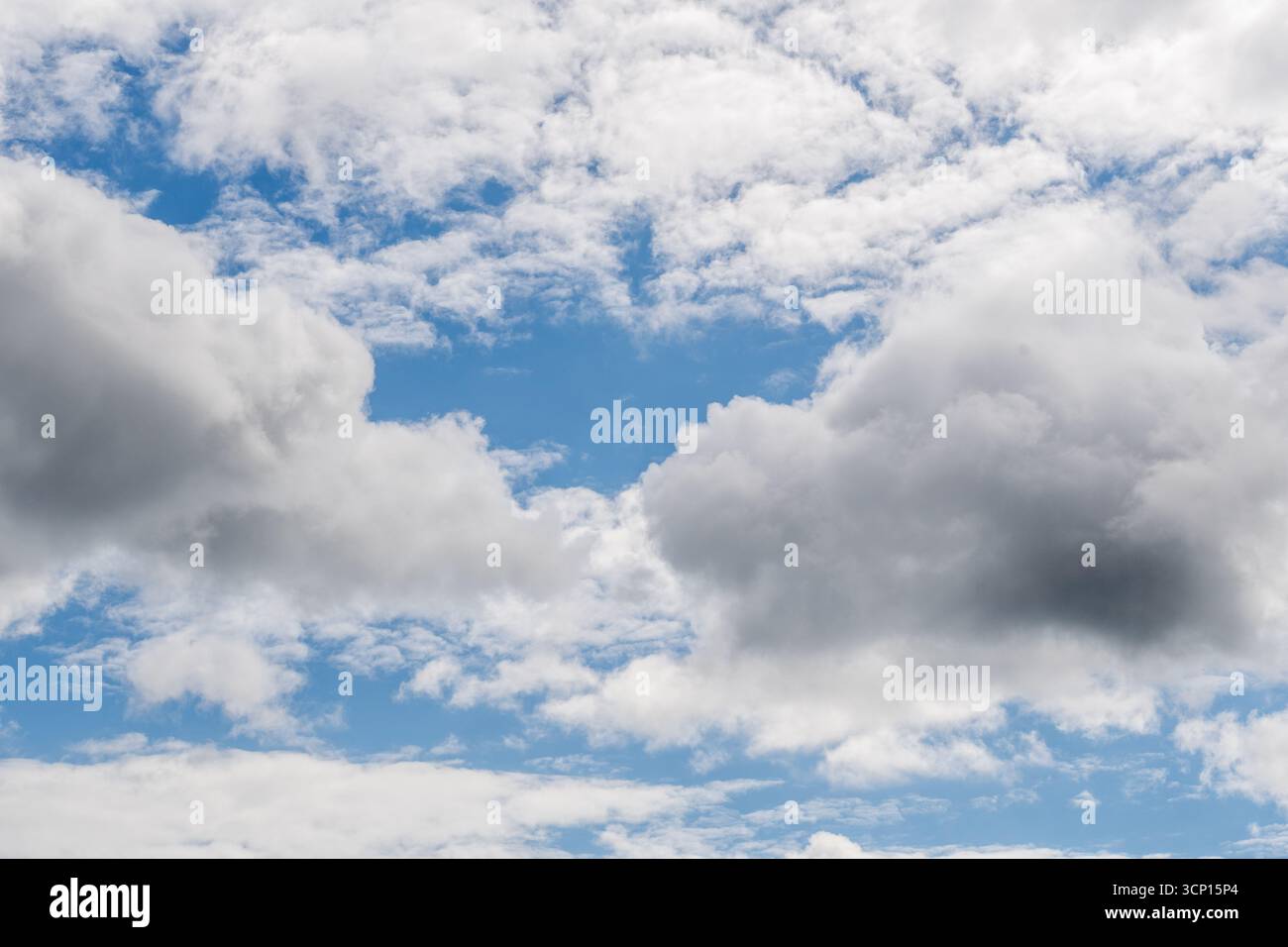 Dense clouds float in blue sky, creating soothing landscape. Natural ...
