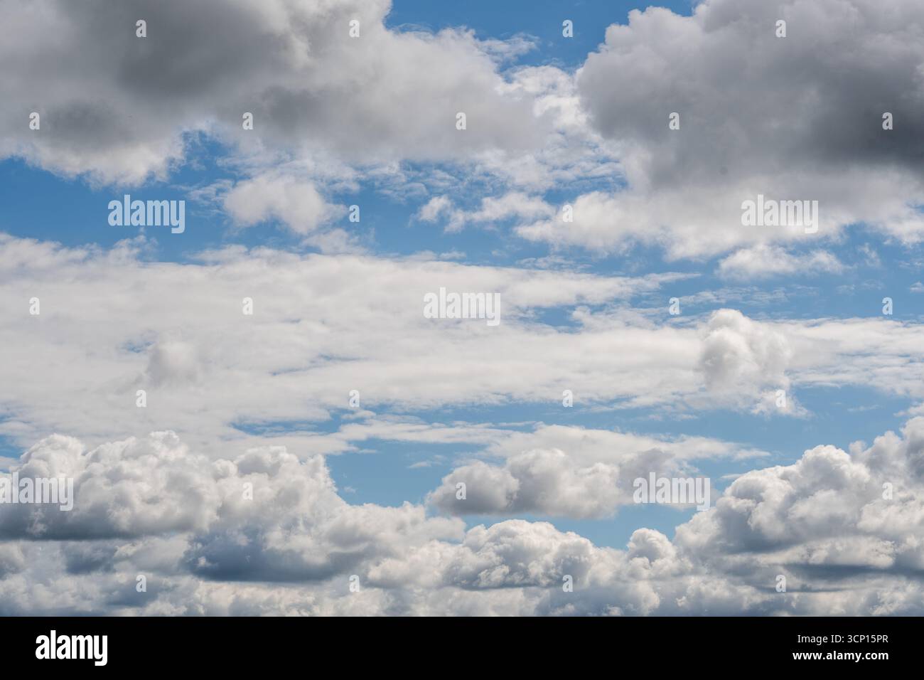 Dense clouds float in blue sky, creating soothing landscape. Natural ...