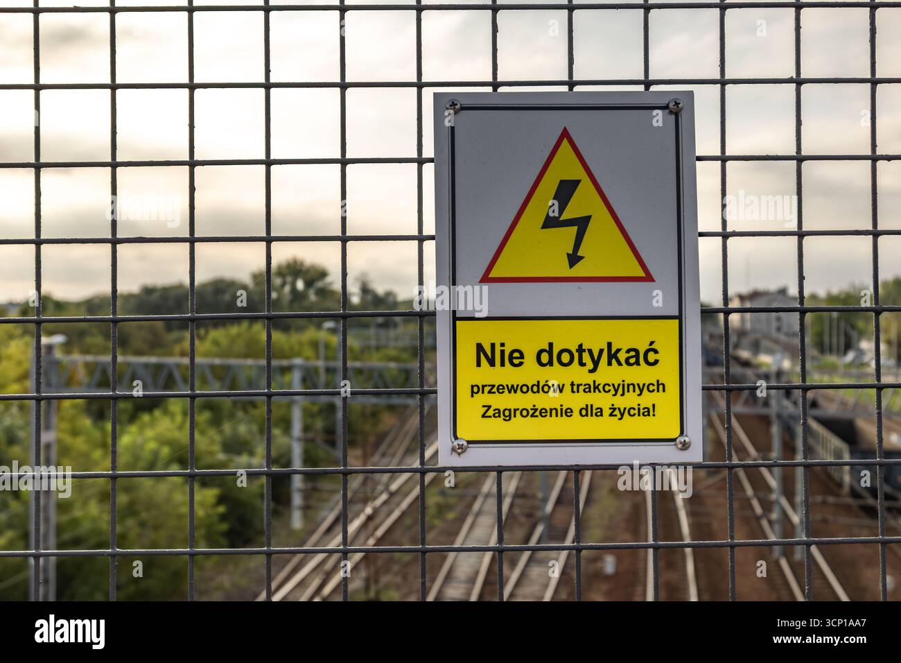 High voltage warning sign, warning sign hanging above the railway ...