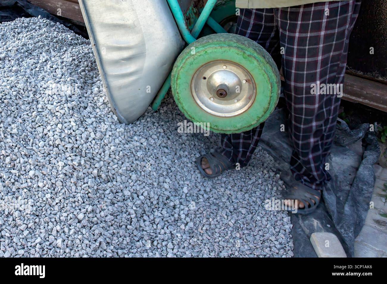Gravel unloading from wheelbarrow. Crushed stone for construction ...