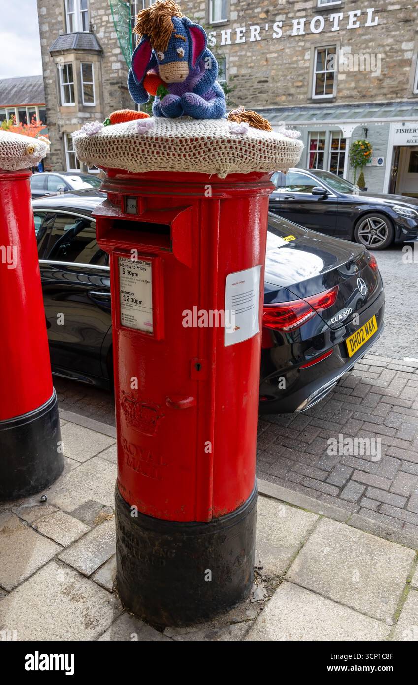Eeyore siting a Red Post Box in the town centre of Pitlochry ...