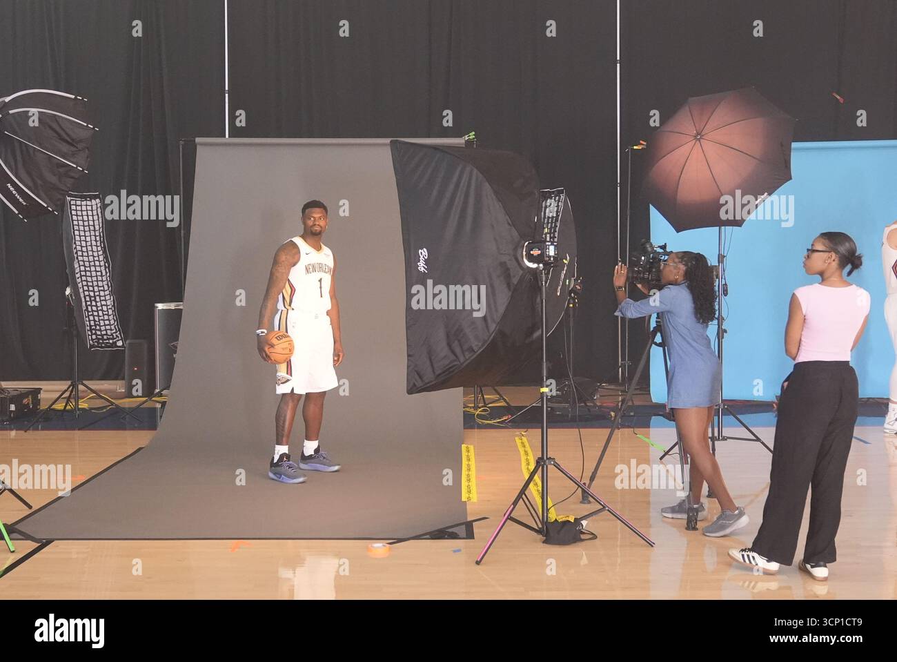 New Orleans Pelicans forward Zion Williamson poses for photos while a ...