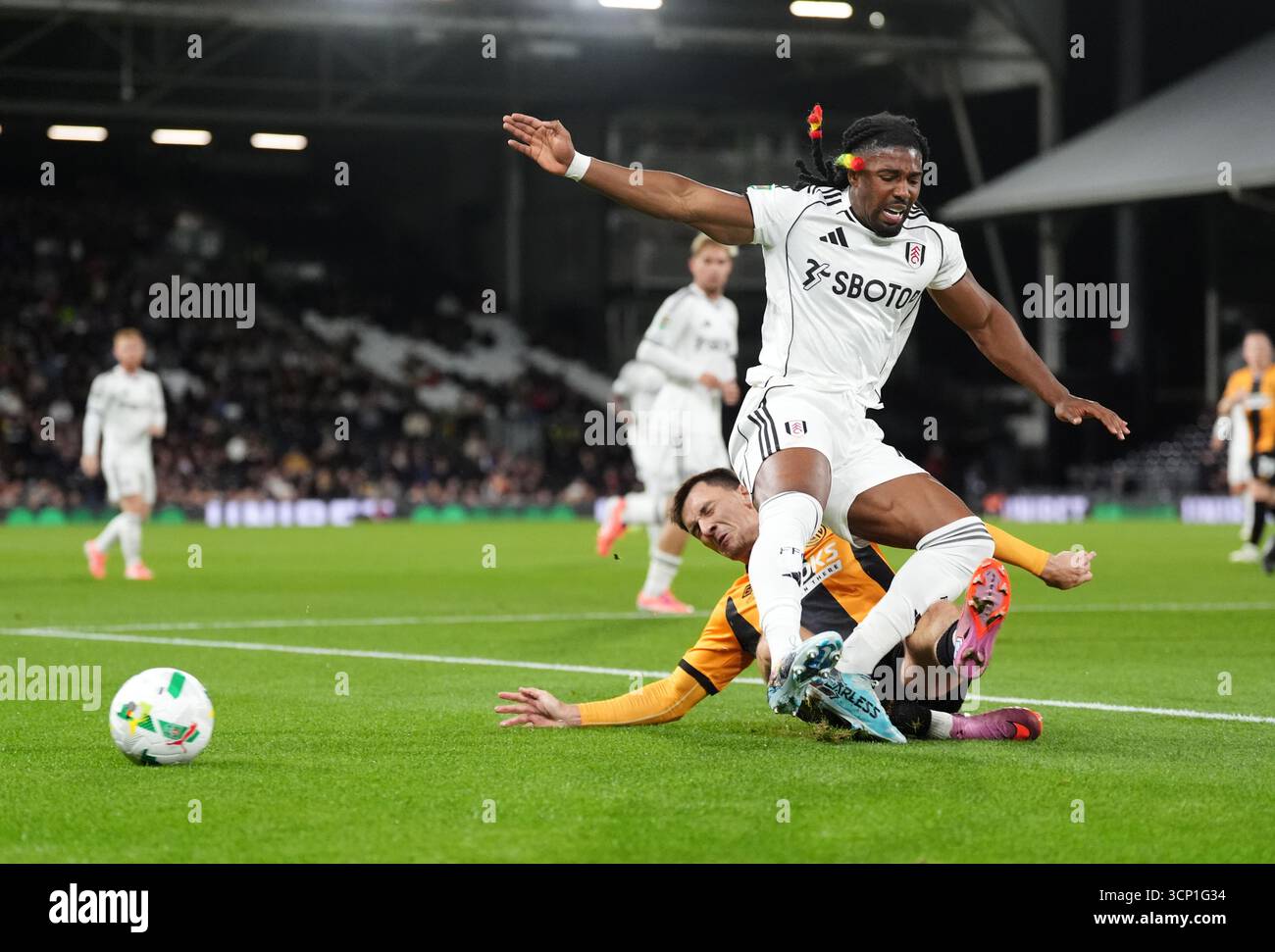 Fulham's Adama Traore is fouled by Cambridge United's Adam Mayor during ...