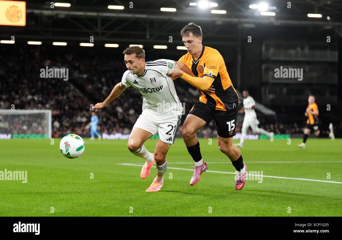 Fulham's Timothy Castagne (left) and Cambridge United's Adam Mayor ...