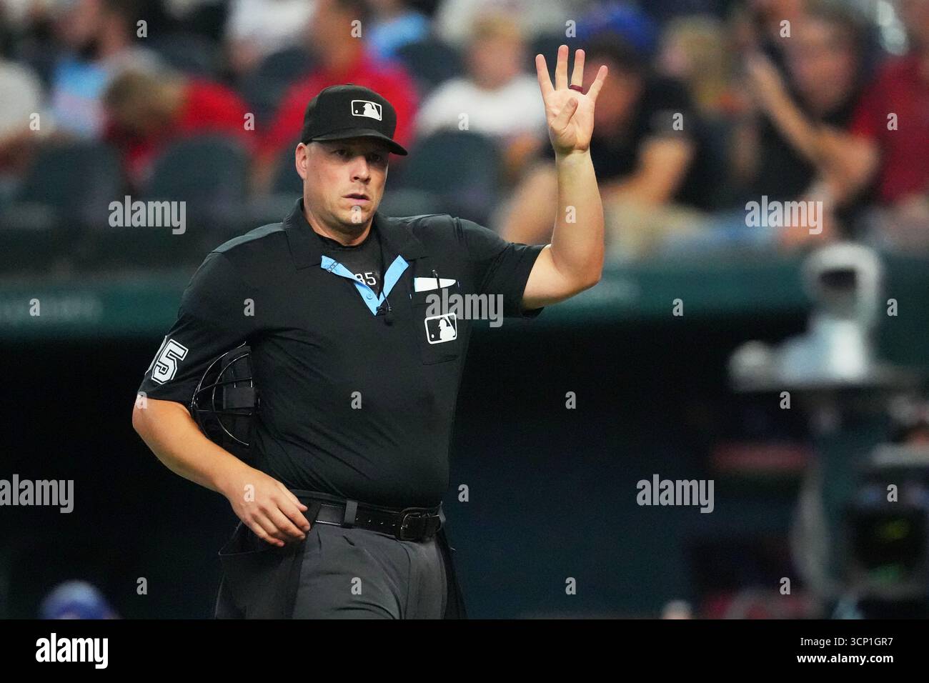 Home plate umpire Stu Scheurwater gestures during the first inning of a ...