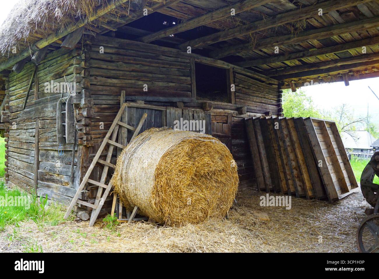 Traditional wooden barn with hay bale storage. Symbol of sustainable ...