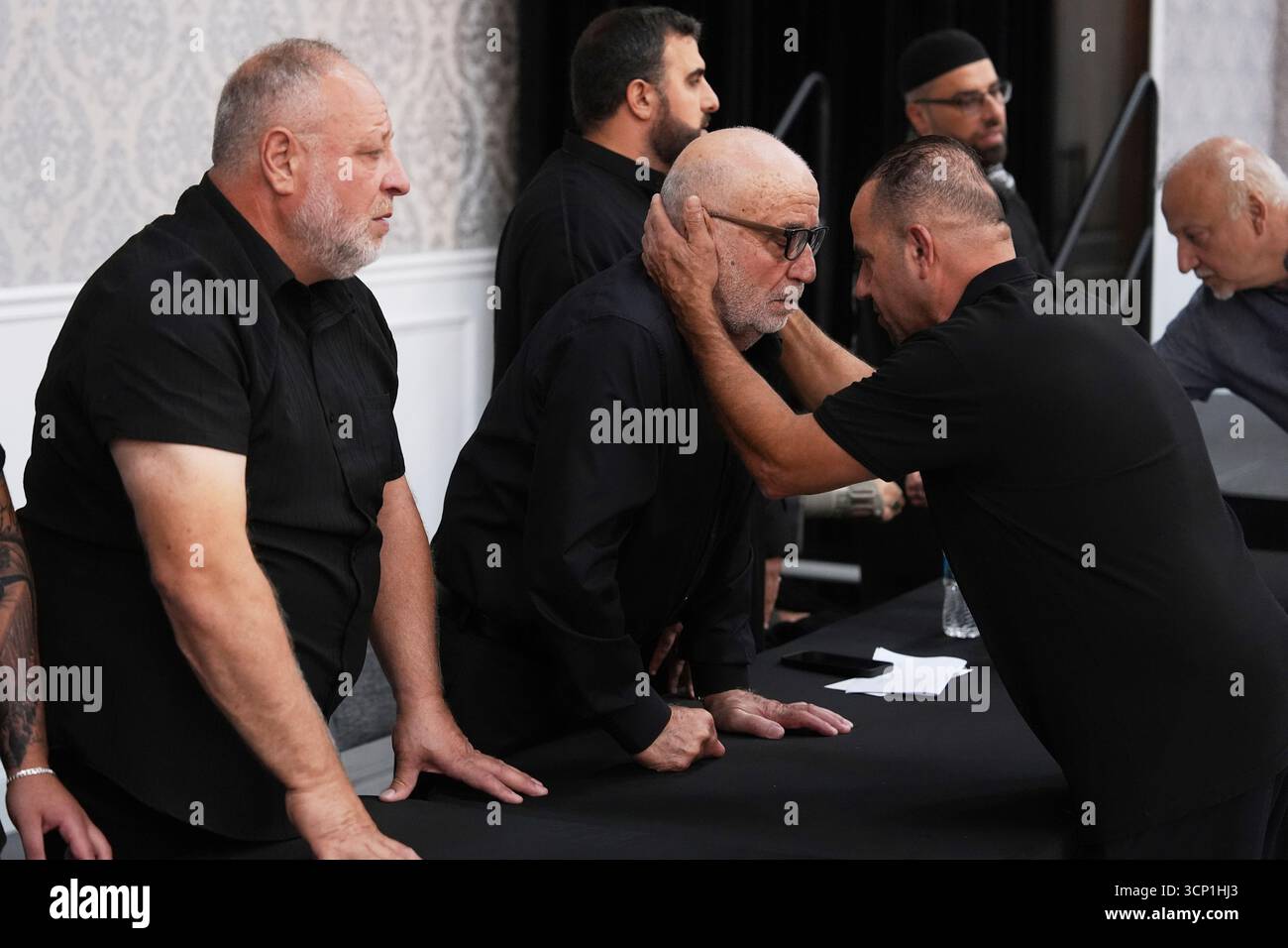 Hajj Sobhi Charara, center, and Hajj Nidal, left, greet mourners for ...