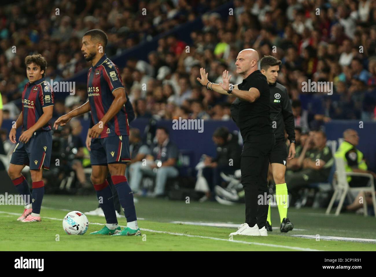Levantes' head coach Julian Calero, gives instructions to his players ...