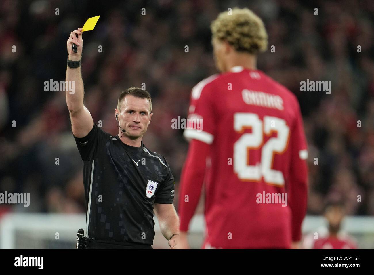 Referee Thomas Bramall shows the yellow card to Liverpool's Hugo ...