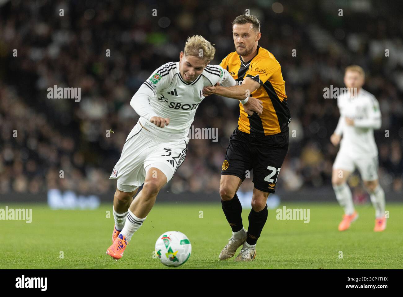 Shane McLoughlin of Cambridge United holding back attacking Emile Smith ...