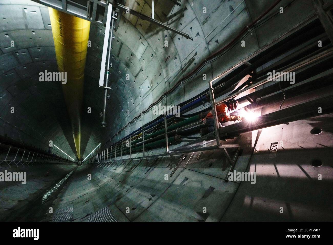 A worker uses a torch during the continued construction of the metro ...