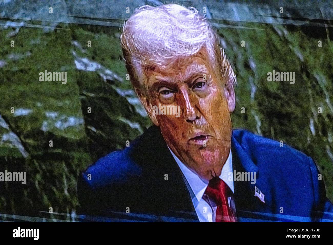 A giant projection screen image of US President Donald J Trump as he ...