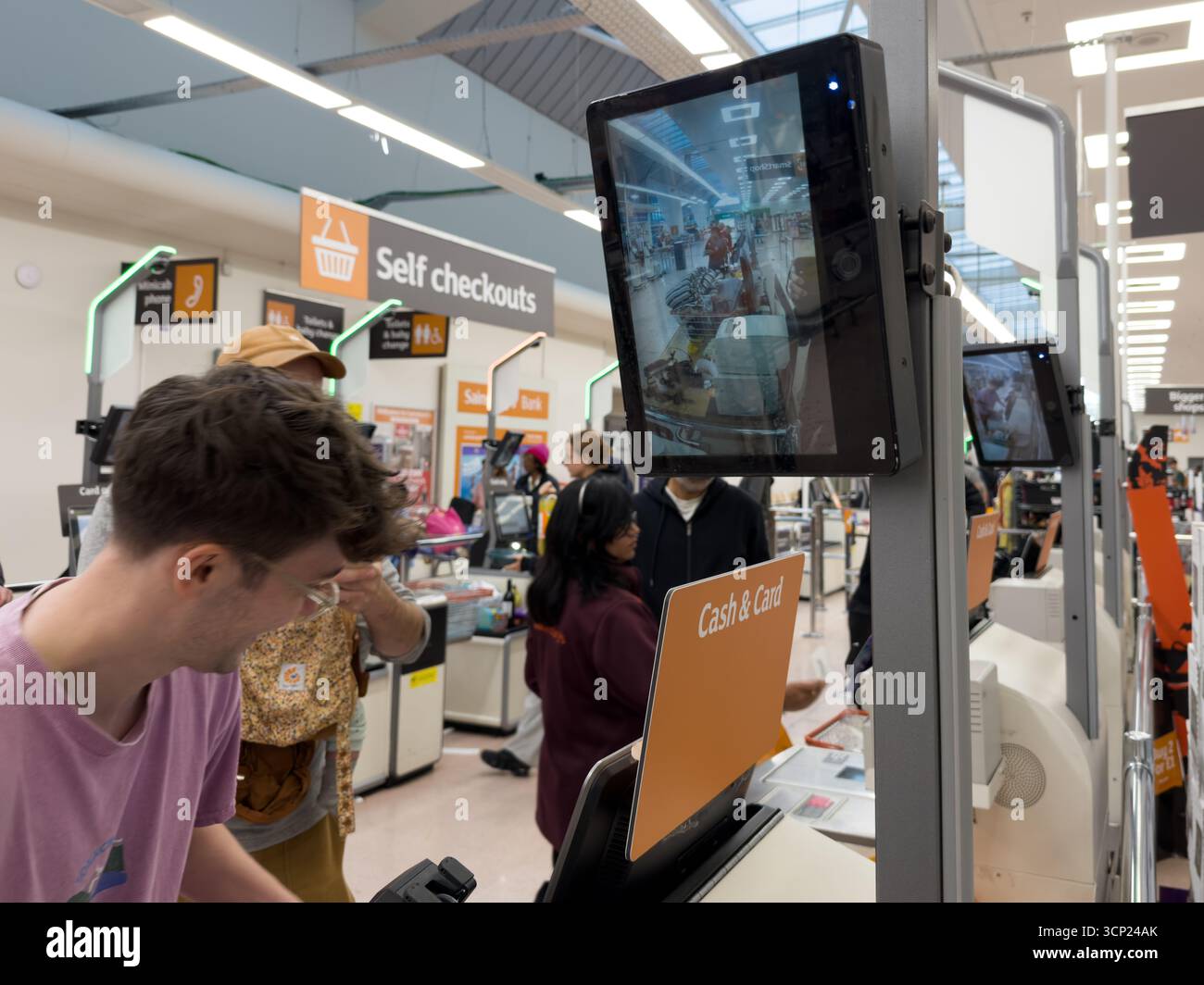 Customers at a London Sainsbury’s supermarket use self-checkout tills ...