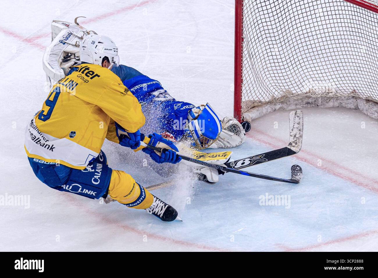 Goalkeeper Leonardo Genoni #30 (EV Zug) has to let the puck through ...