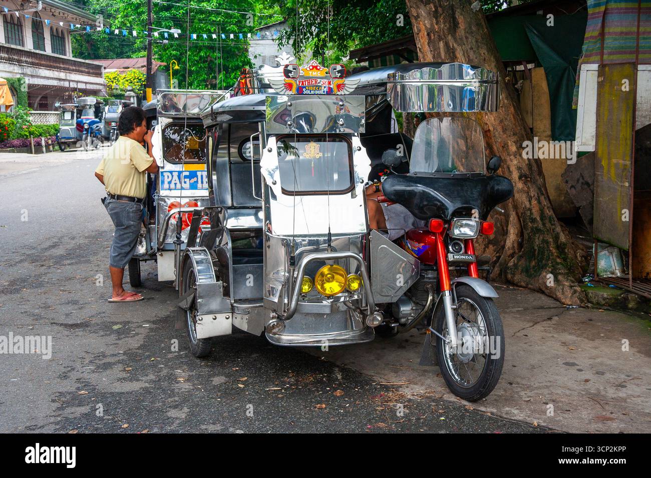 A line of Philippine traditional tricycles at a local town terminal in ...