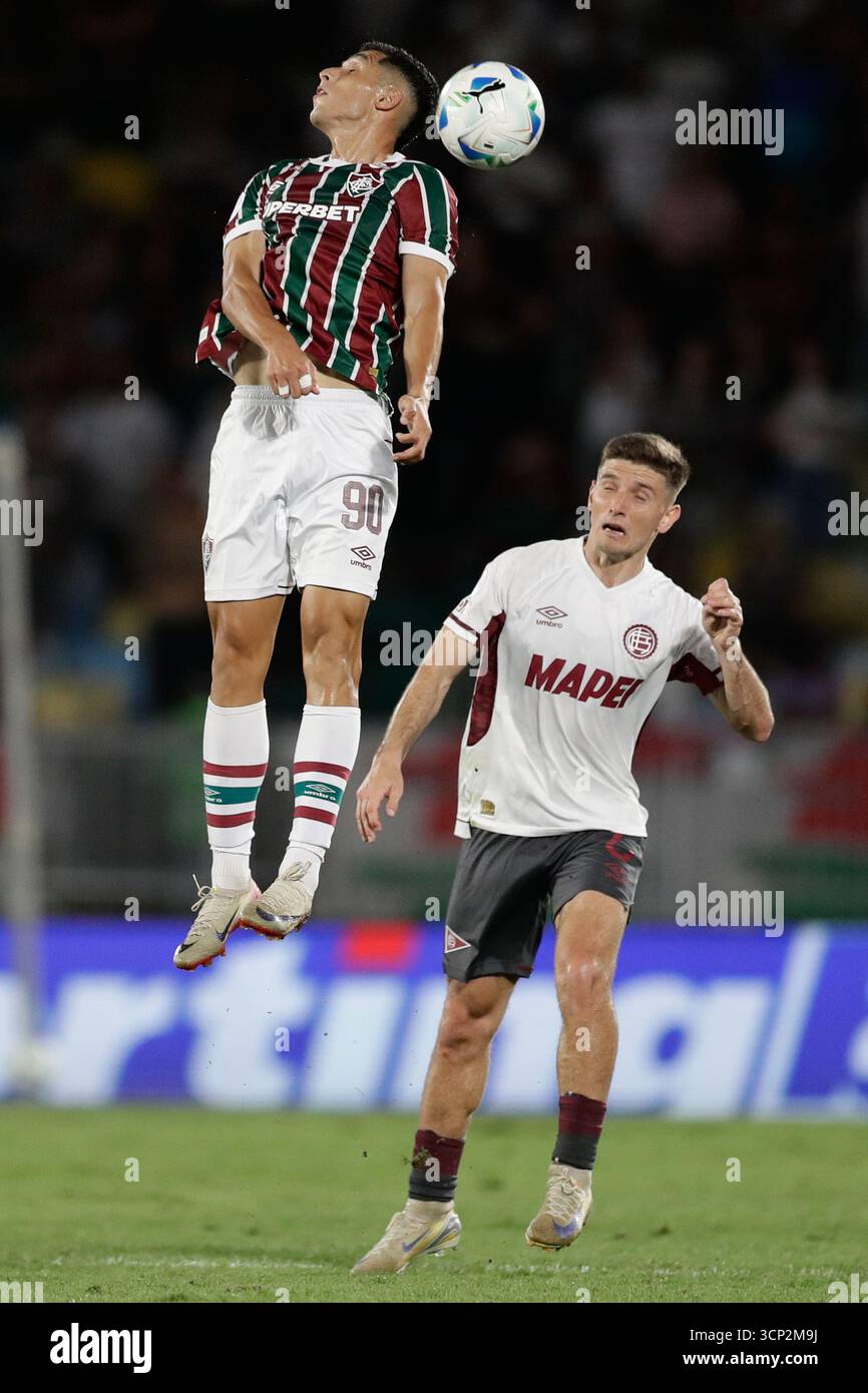 Kevin Serna of Brazil's Fluminense jumps for a header challenged by ...