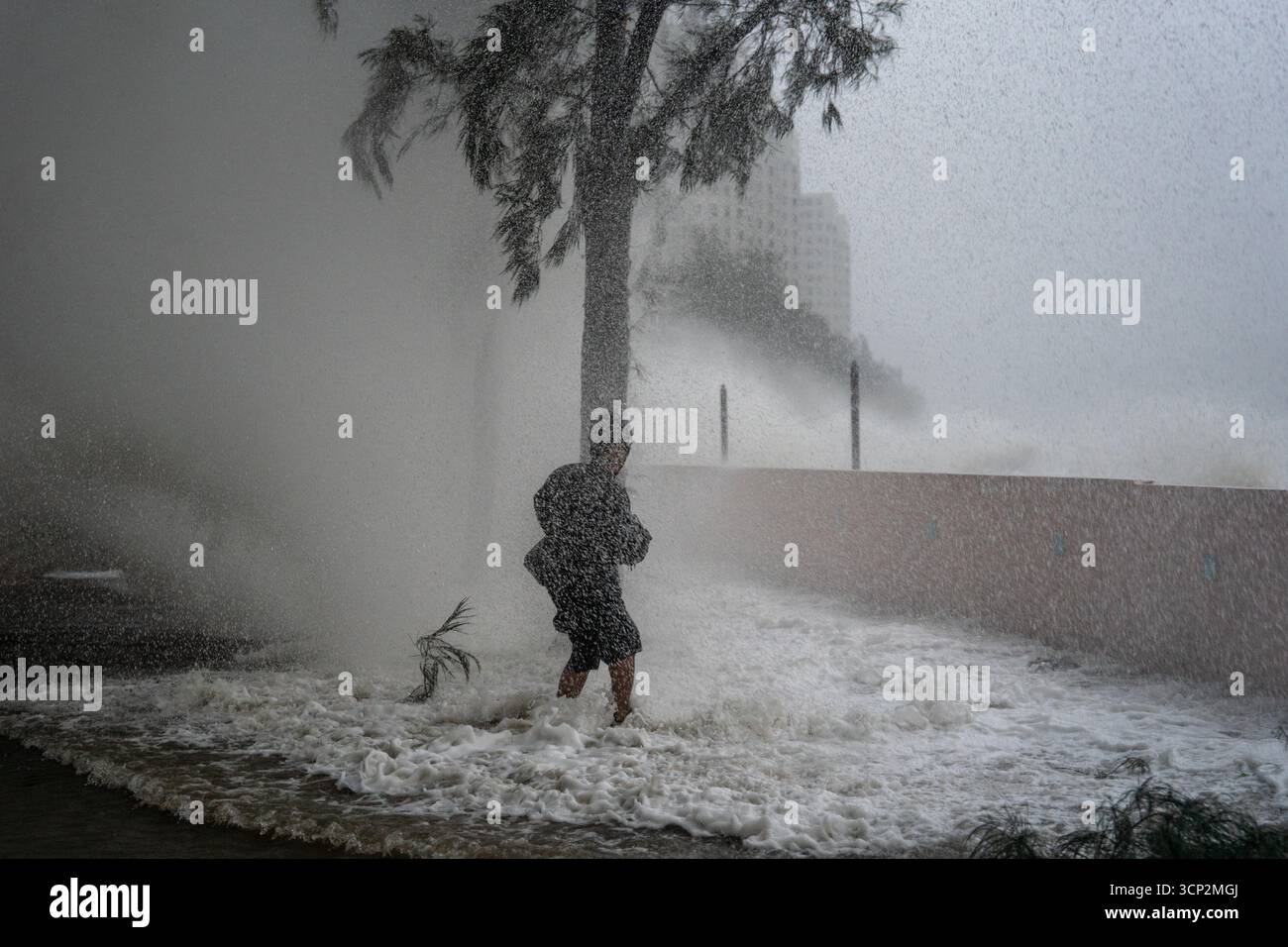 Hong Kong, Hong Kong. 24th Sep, 2025. A man being splash by waves at ...