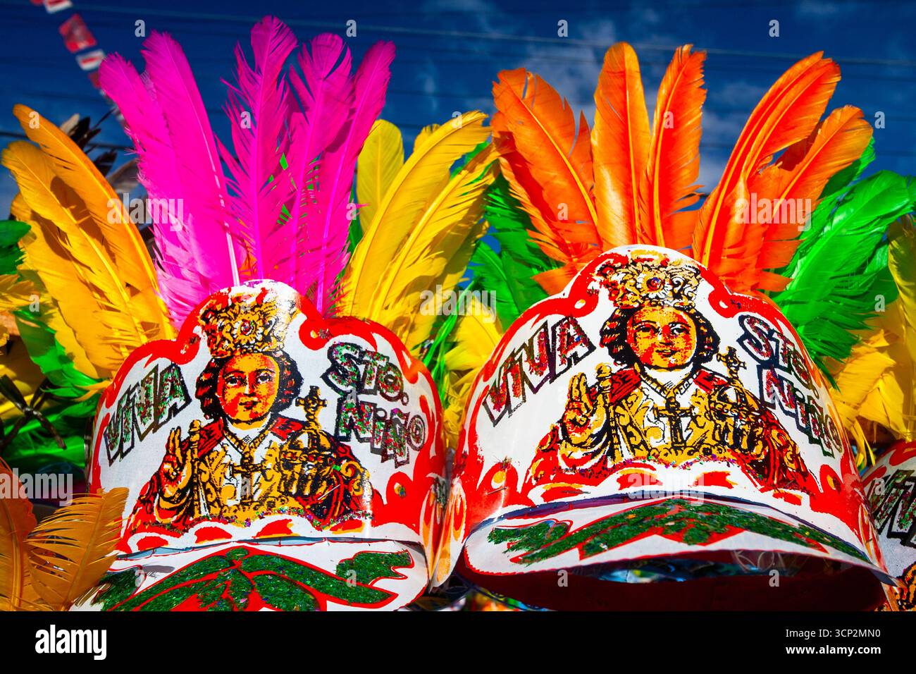 Colorful Sinulog Festival hats with feathers displayed at a roadside ...