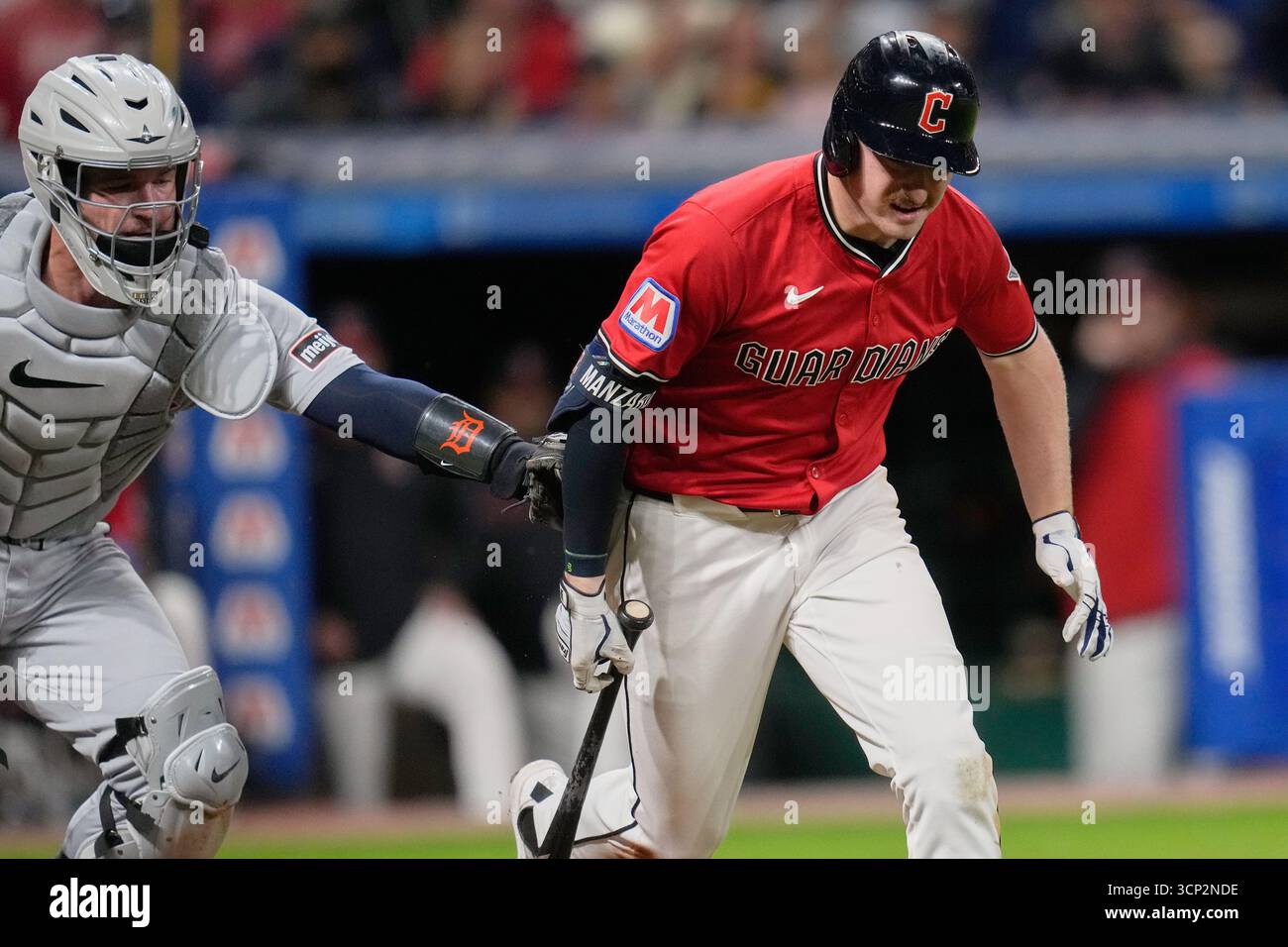 Cleveland Guardians' Kyle Manzardo, right, is tagged out by Detroit ...