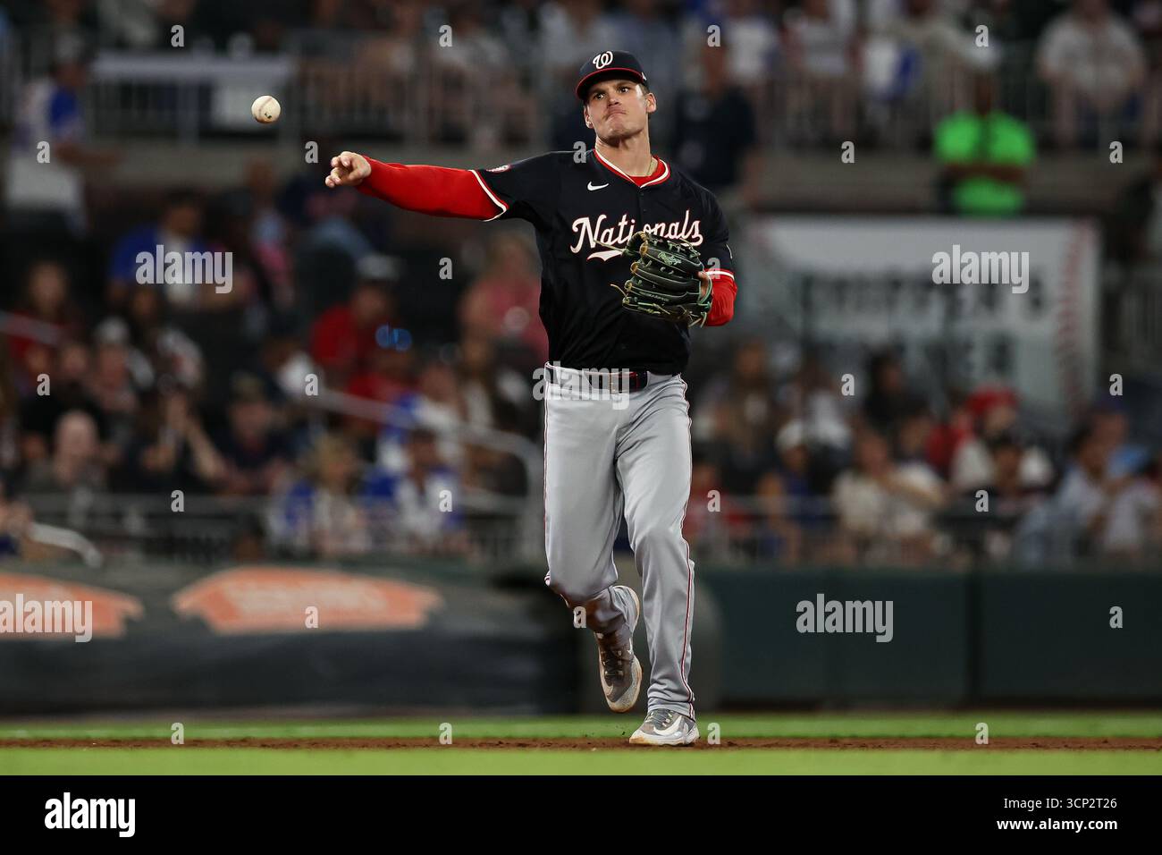 Washington Nationals third baseman Brady House throws to first base in ...