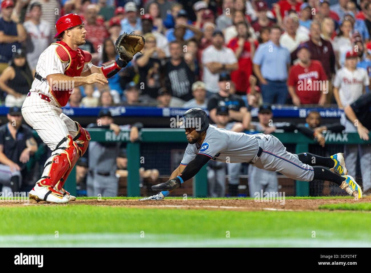 Miami Marlins' Otto Lopez, center, scores before Philadelphia Phillies ...