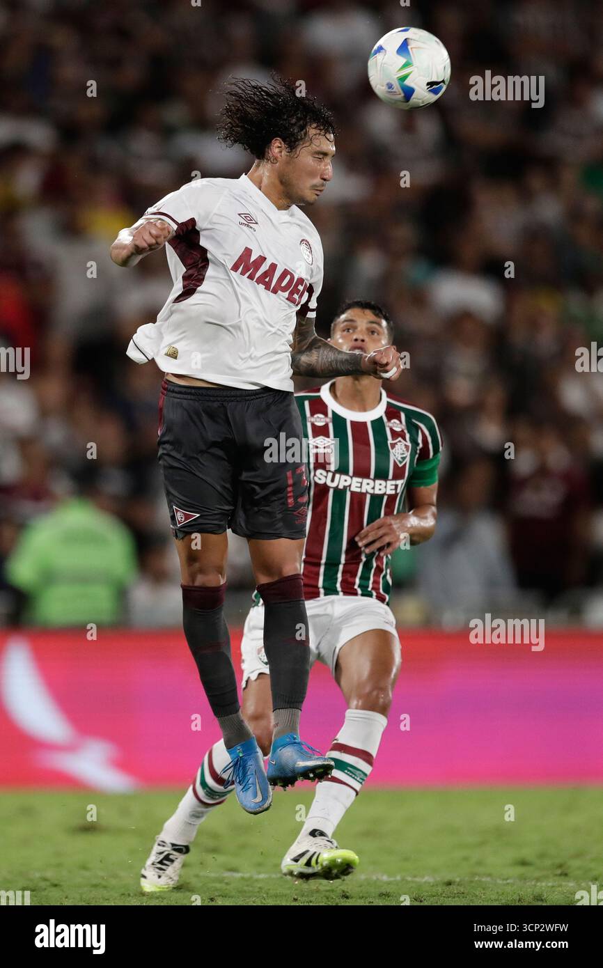 Jose Canale of Argentina's Lanus heads the ball challenged by Thiago ...