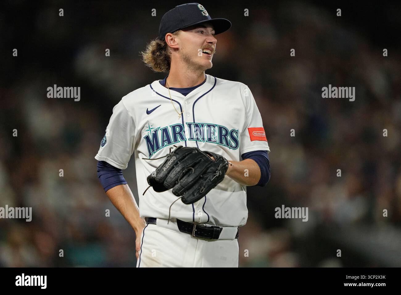 Seattle Mariners starting pitcher Bryce Miller reacts after being hit ...
