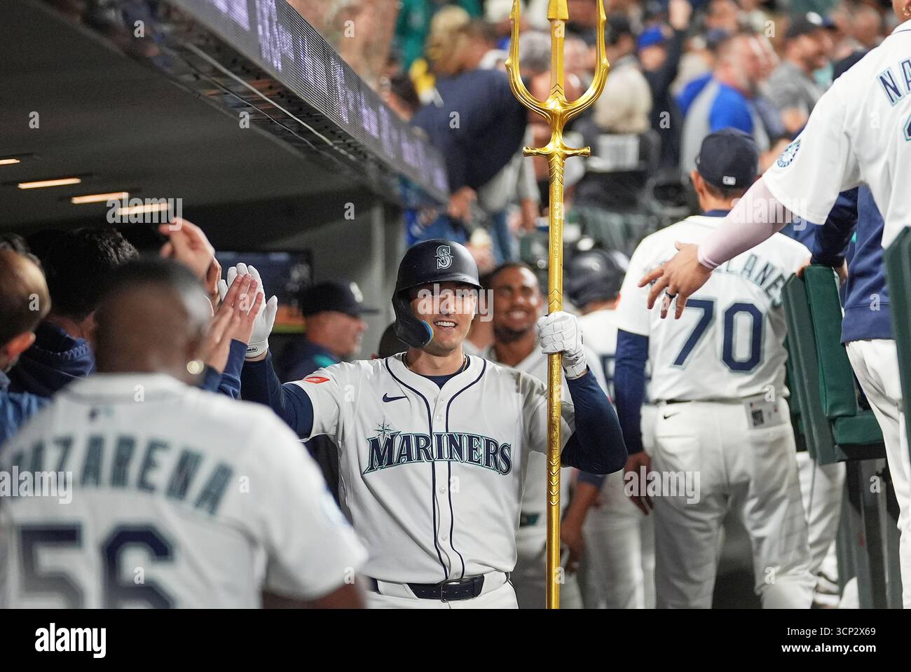 Seattle Mariners' Dominic Canzone celebrates in the dugout after ...